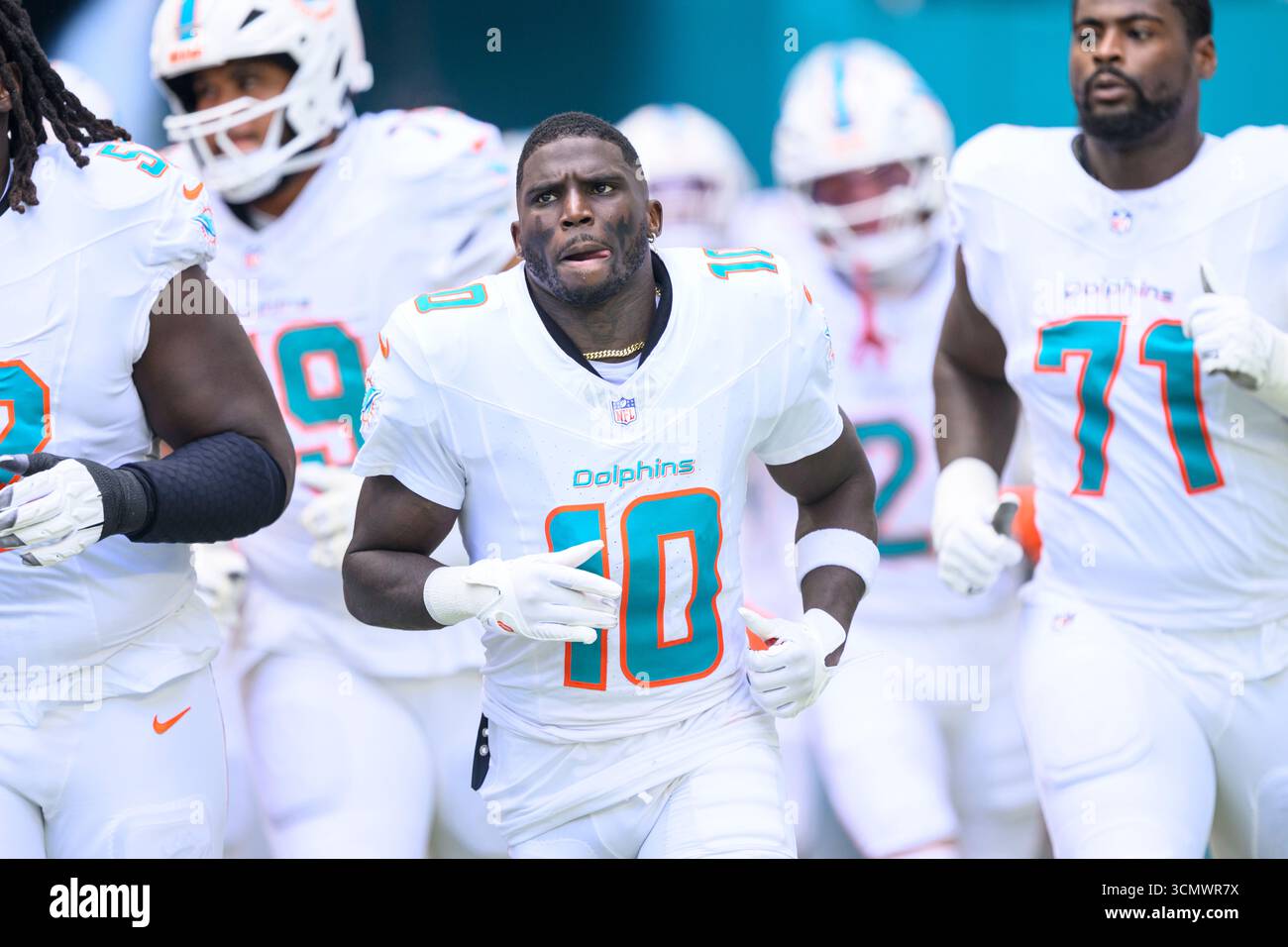 Miami Dolphins wide receiver Tyreek Hill (10) runs onto the field ...