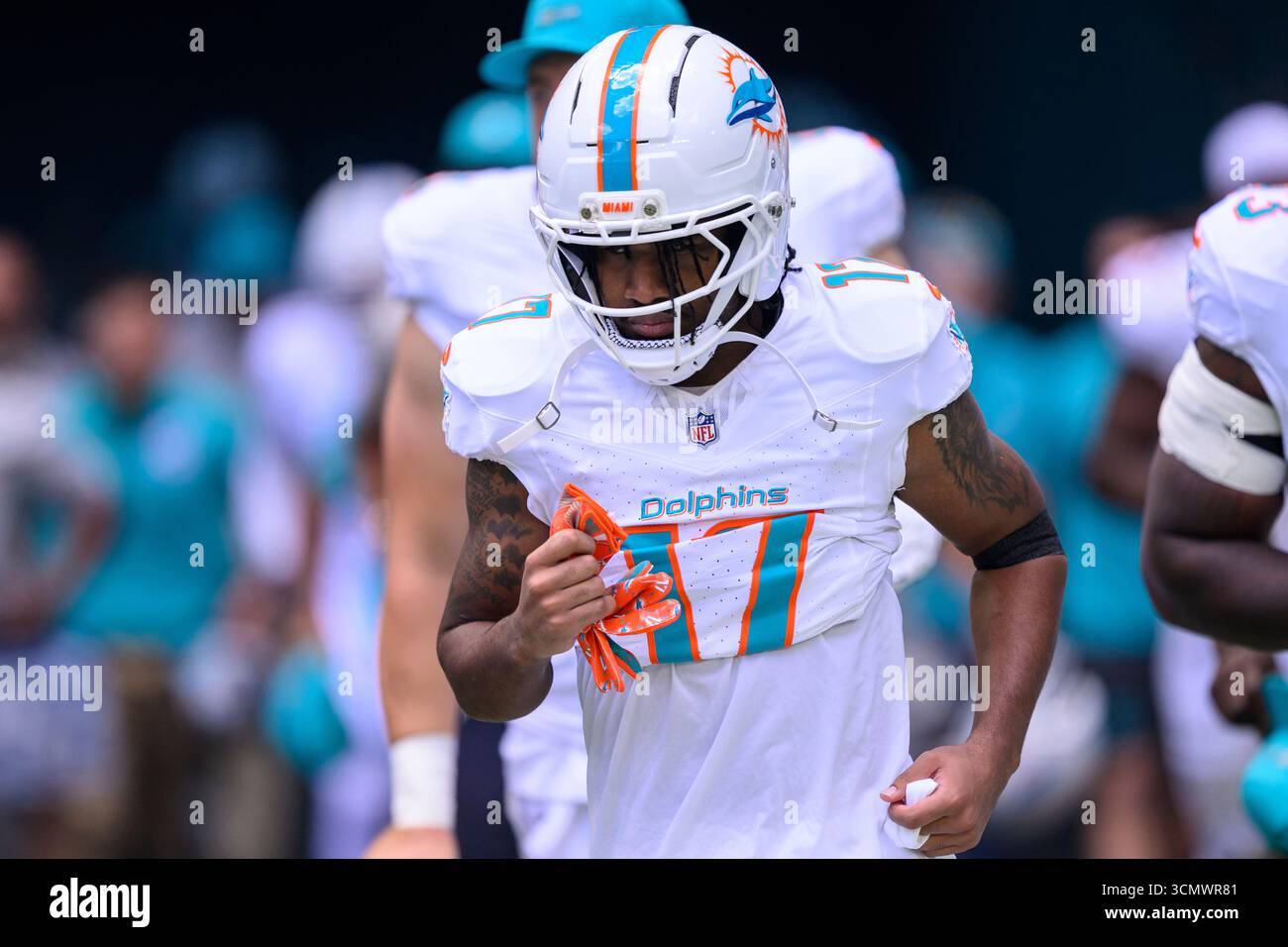 Miami Dolphins wide receiver Jaylen Waddle (17) runs onto the field ...