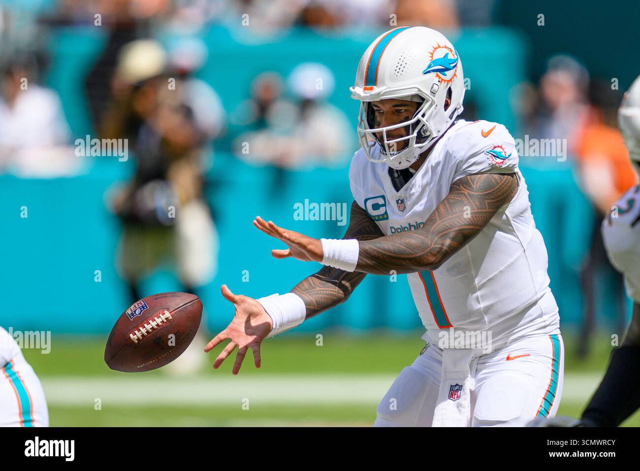 Miami Dolphins quarterback Tua Tagovailoa (1) takes the snap of he ball ...