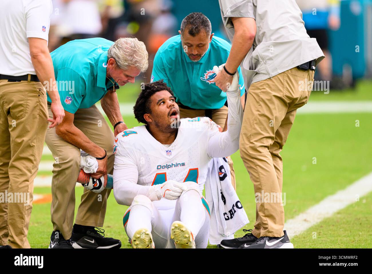Miami Dolphins linebacker Chop Robinson (44) is helped up off the field ...