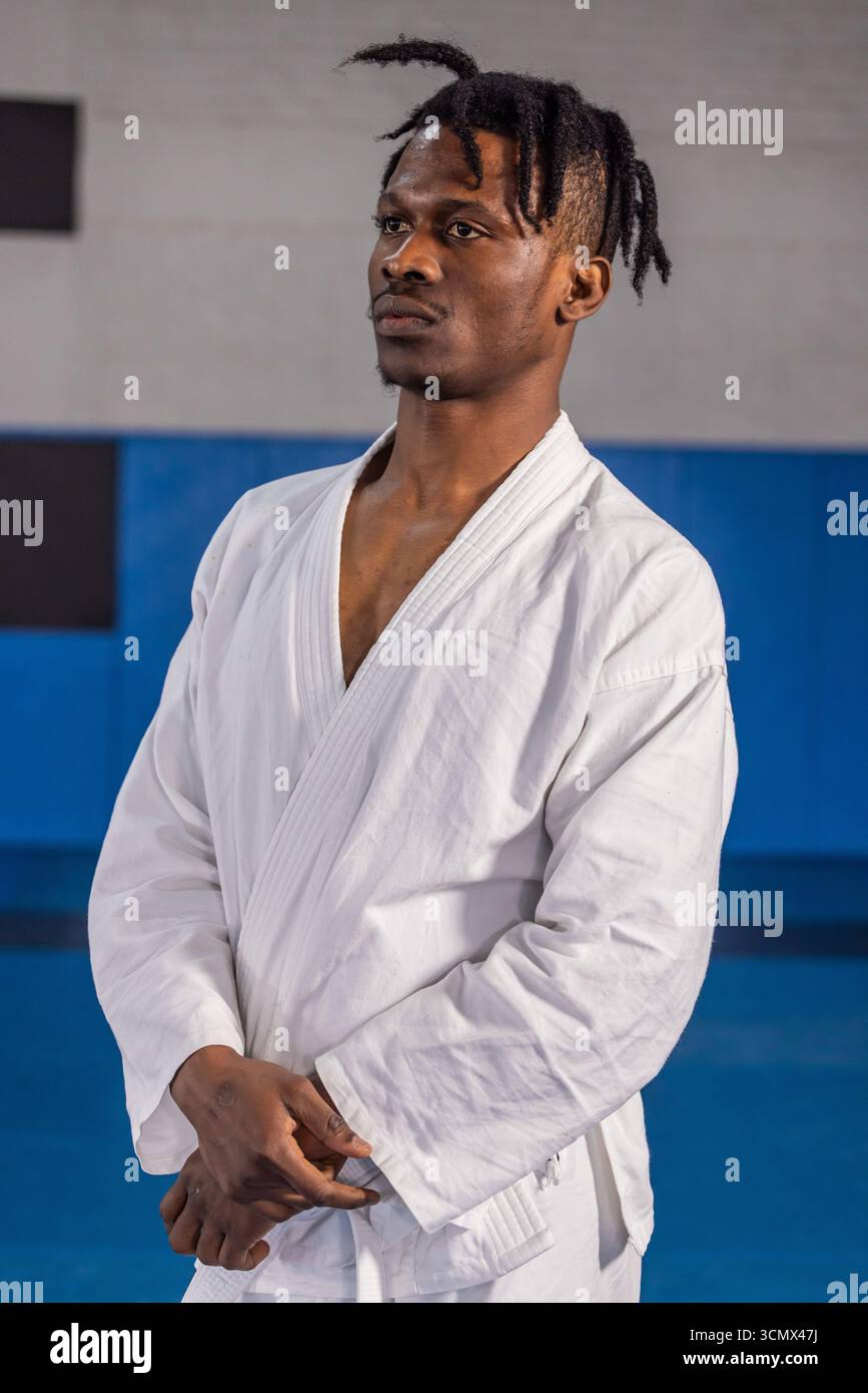 African american man practicing martial arts at dojo in white gi jacket ...