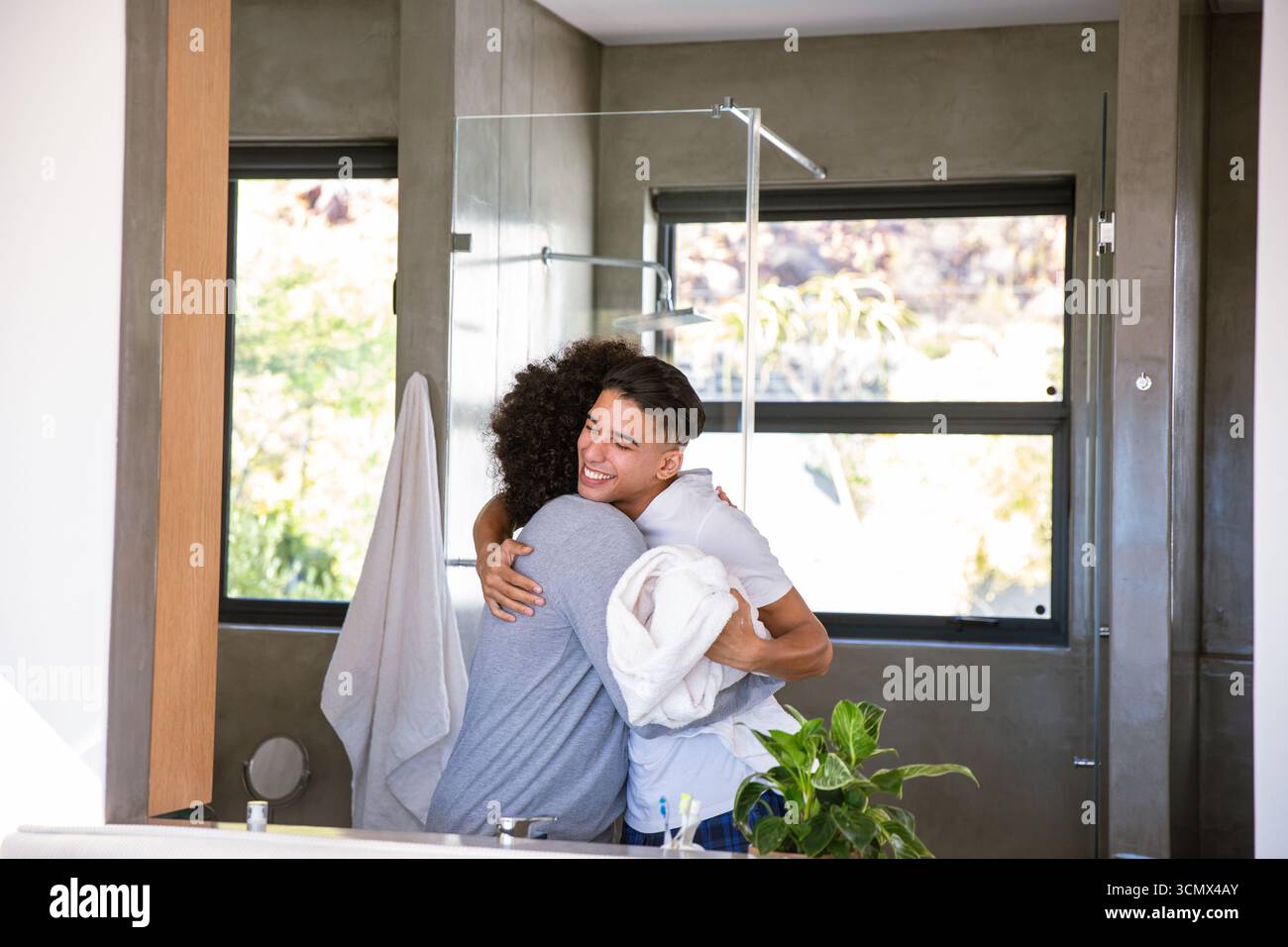 Young couple hugging shower hi-res stock photography and images - Alamy