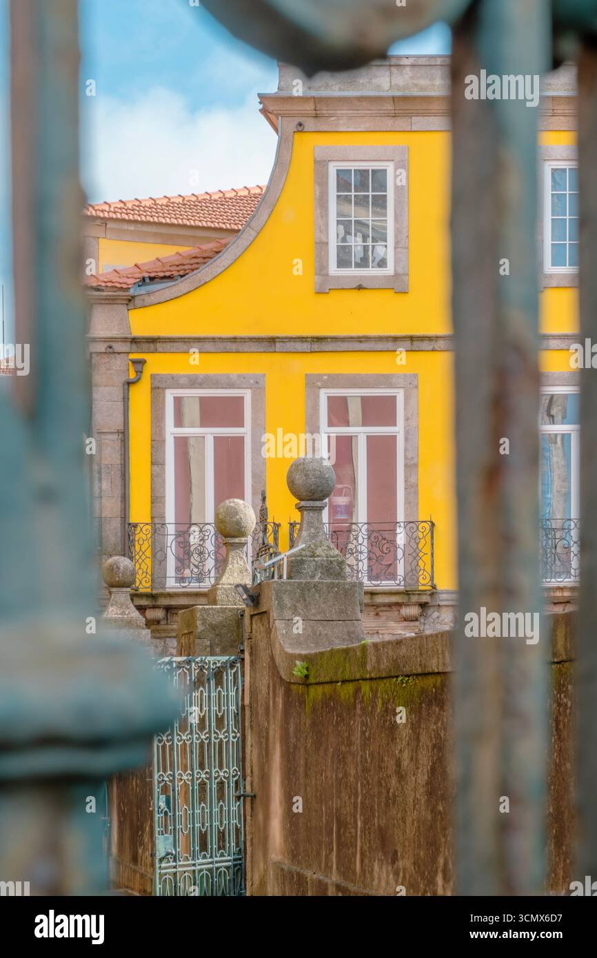 Yellow Building With Curved Gable and White-Framed Windows Behind ...