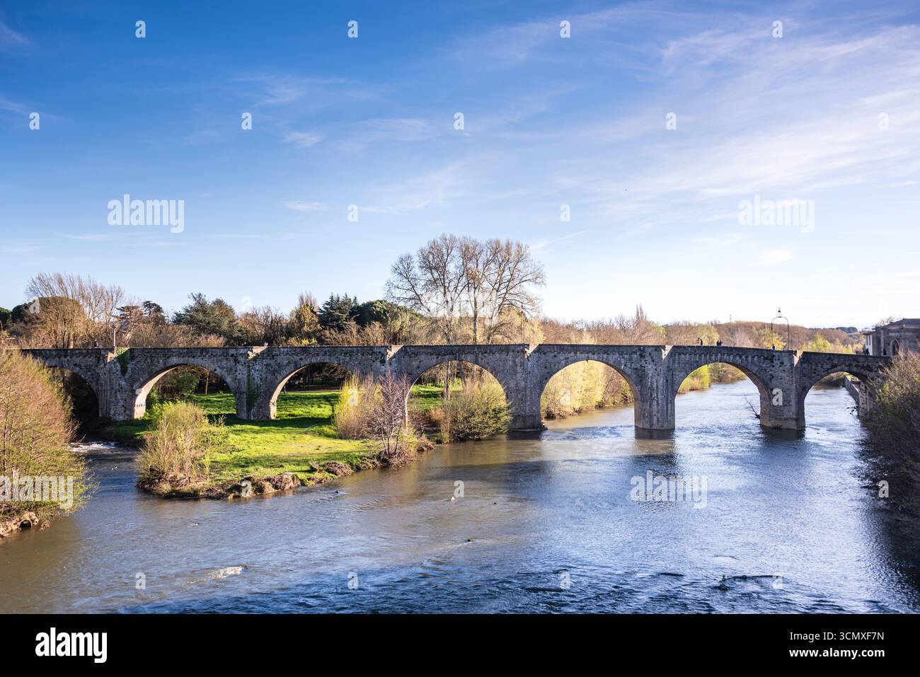 Arched stone bridge Pont Vieux in river Aude. Medieval castle of ...