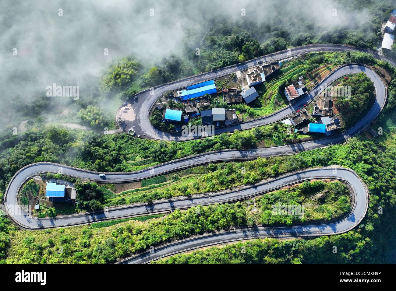 Aerial photo shows the winding mountain road in Youyang County ...