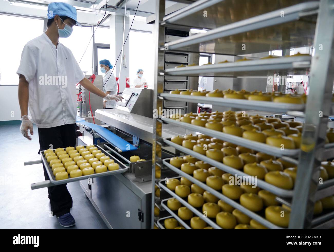 Employees make mooncakes at a food workshop in Leqing City, east China ...