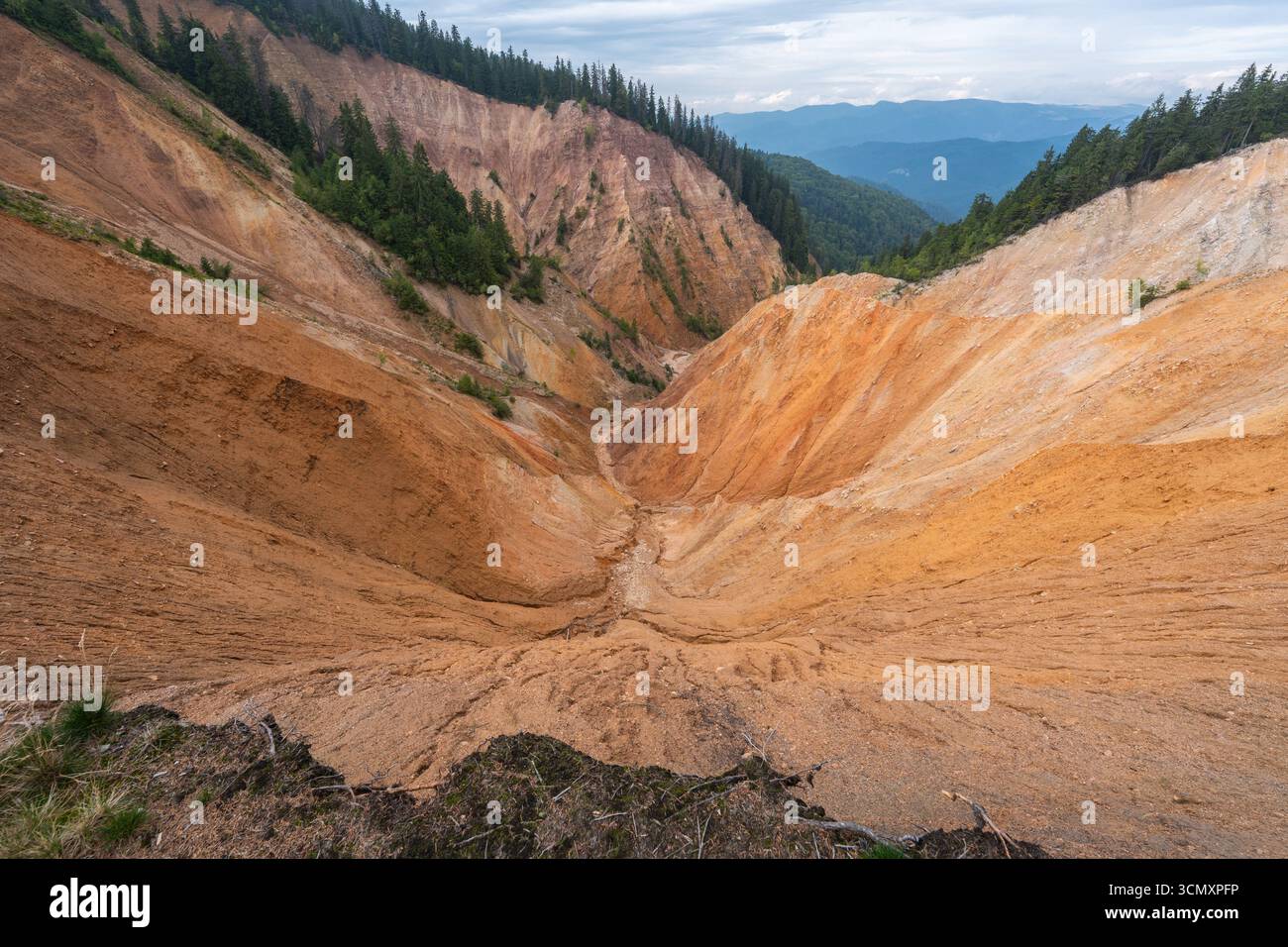 Sweeping ultrawide vista of Groapa Ruginoasa with colorful eroded ...