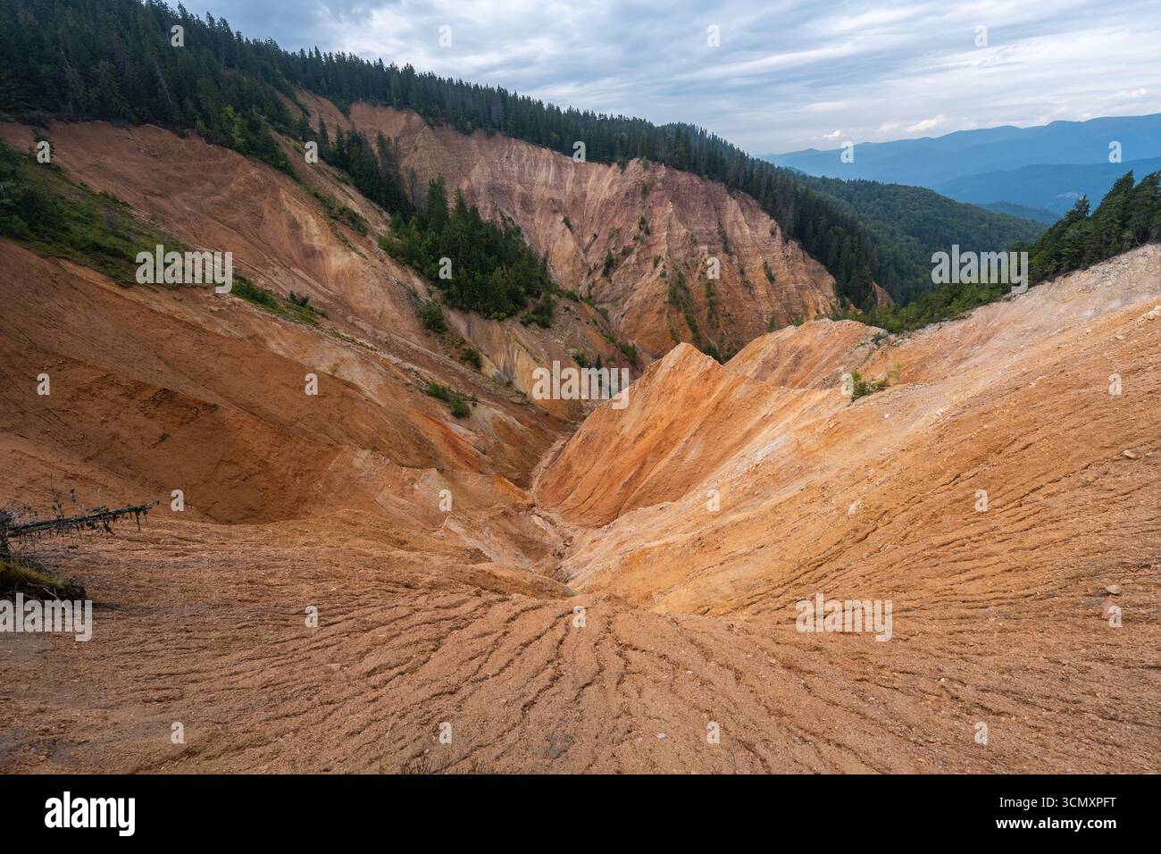 Sweeping ultrawide vista of Groapa Ruginoasa with colorful eroded ...