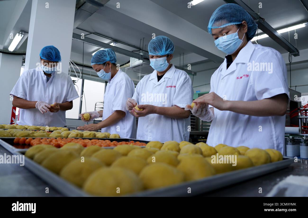 Employees make mooncakes at a food workshop in Leqing City, east China ...