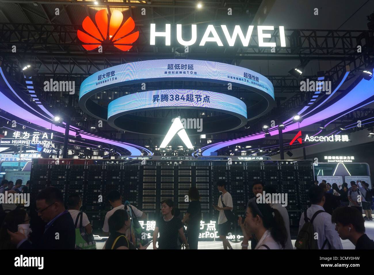 Visitors pass by the Huawei Atlas 900 A3 SuperPoD exhibited at the ...