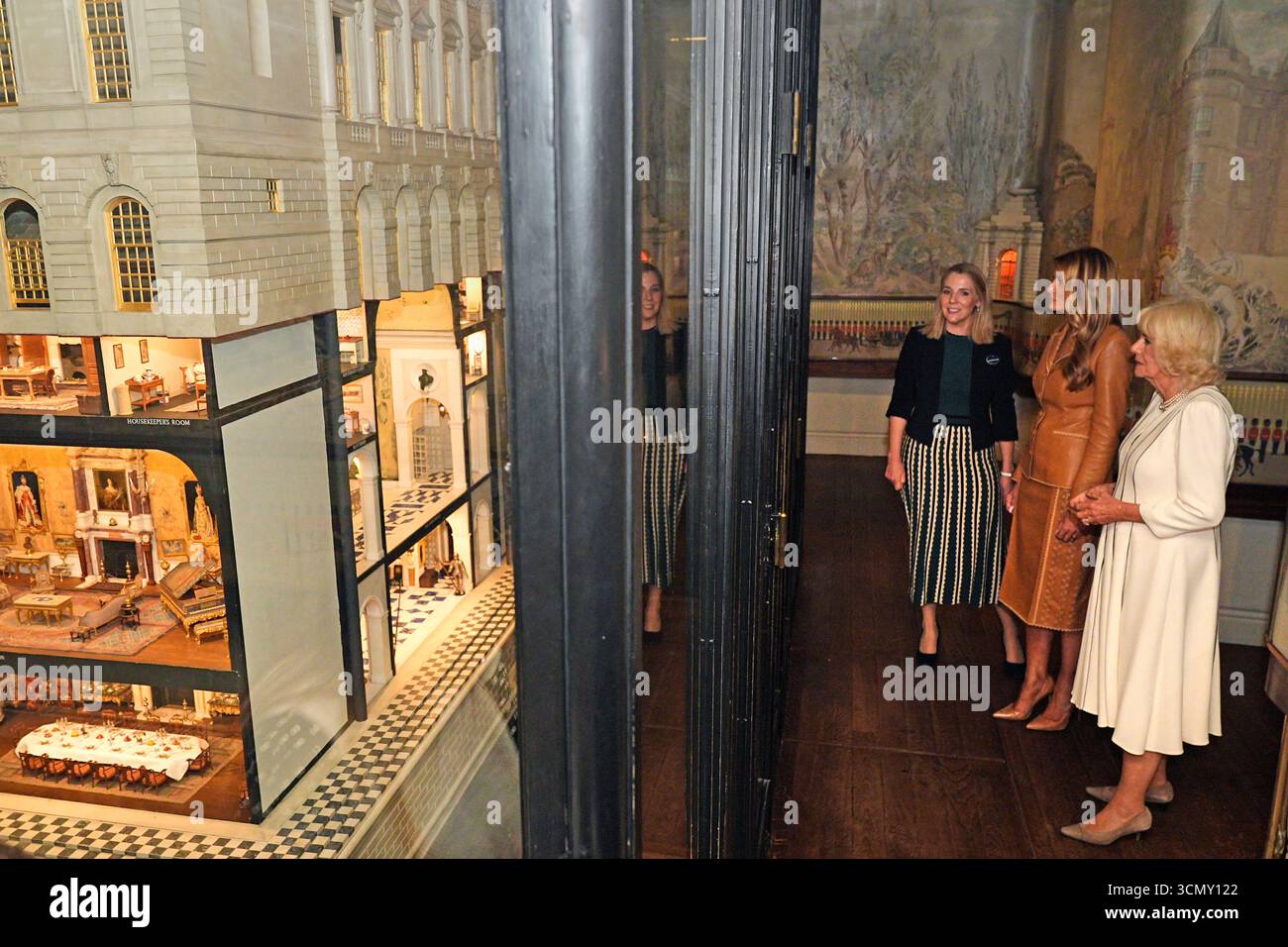 Queen Camilla (right) and First Lady Melania Trump (centre) look at ...