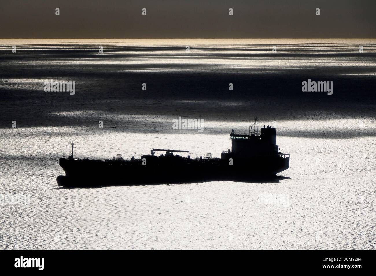 A container ship silhouette on the sea aerial Stock Photo - Alamy