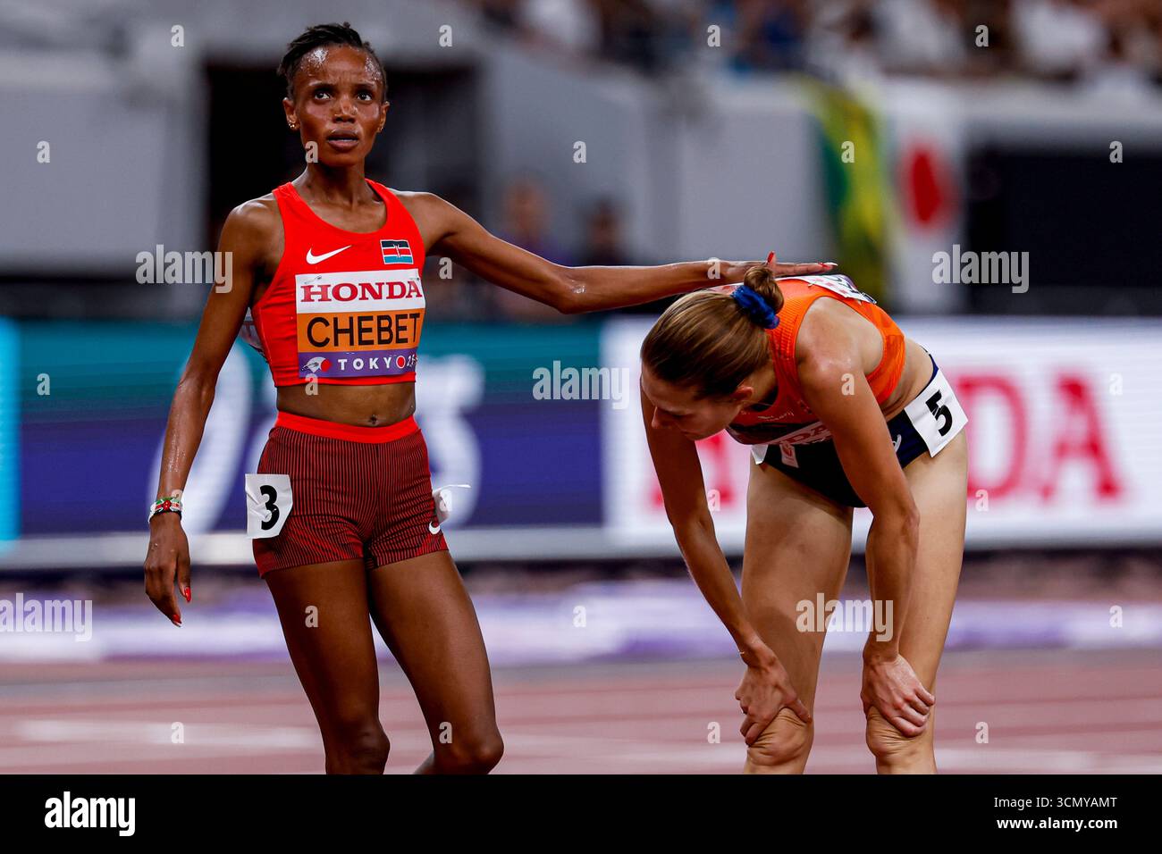 Beatrice Chebet of Kenya looks on and Maureen Koster of the Netherlands ...