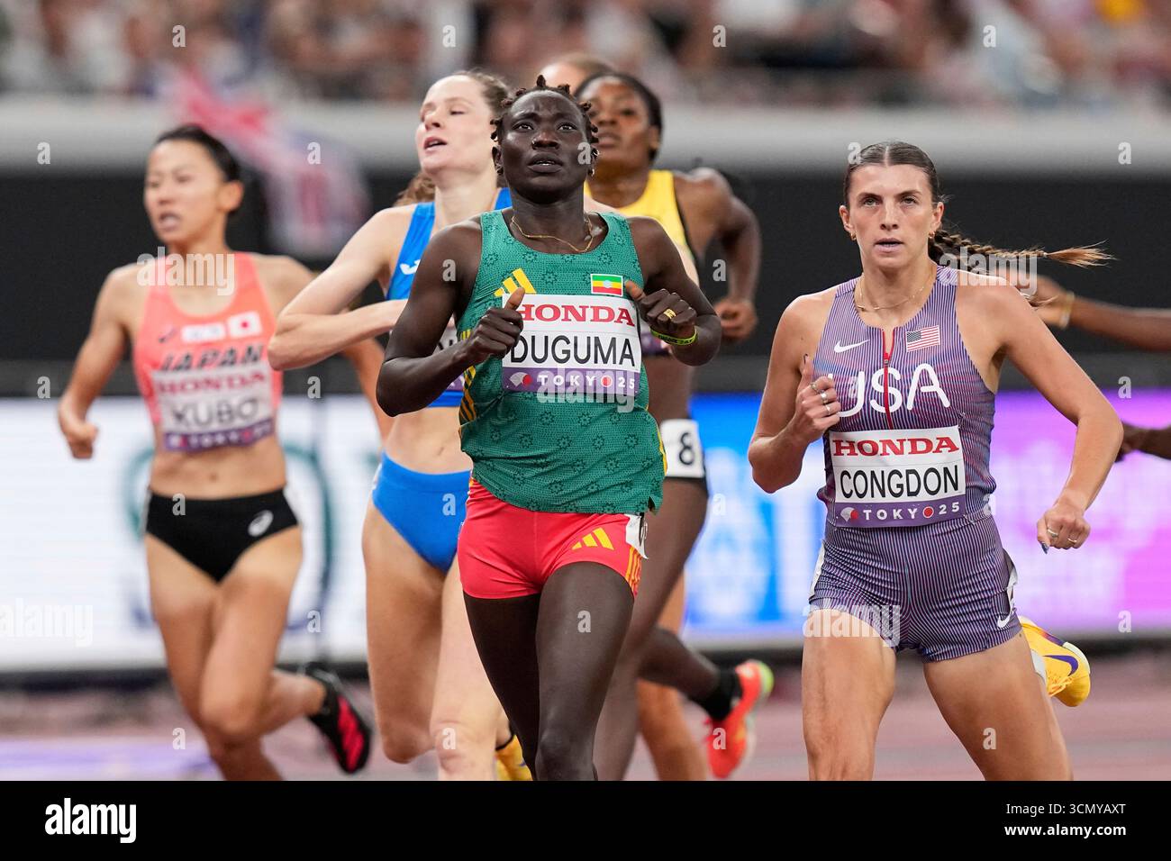 Ethiopia's Tsige Duguma, center, races alongside United States' Maggi ...