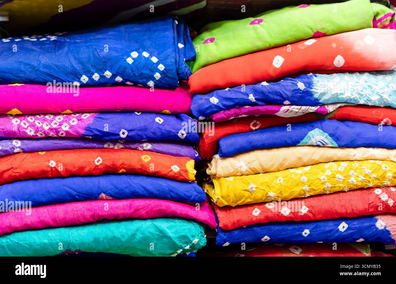 stack of indian traditional colorful saree at retail store at indoor ...
