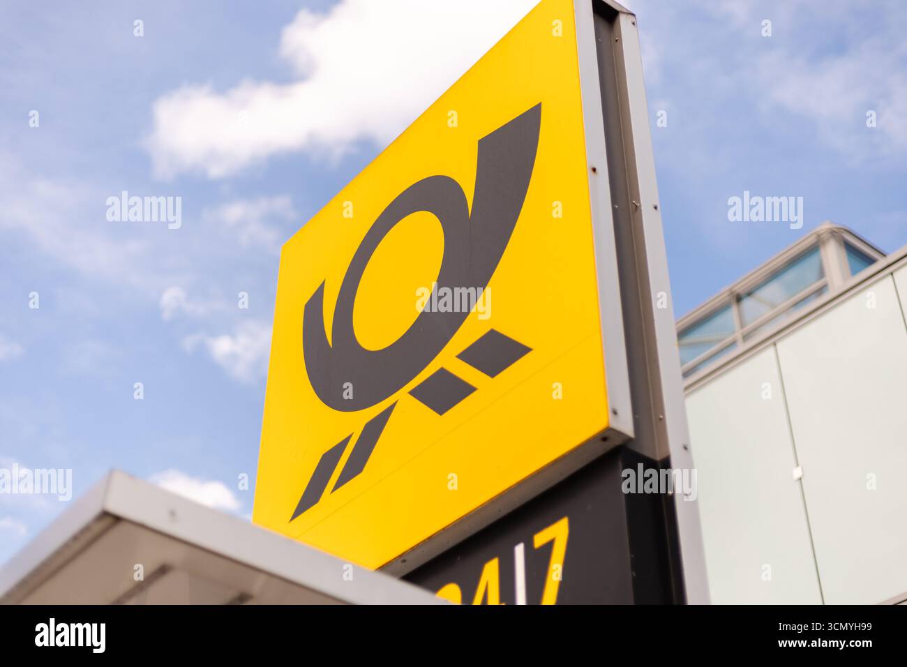Berlin, Germany - September 1, 2025: Bright yellow postal service sign ...
