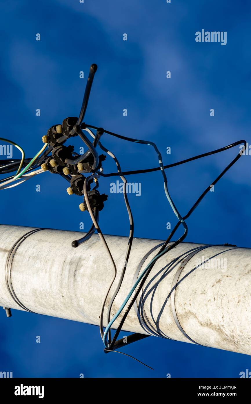 A cut power line, a broken power line, cut wires on a power pole ...