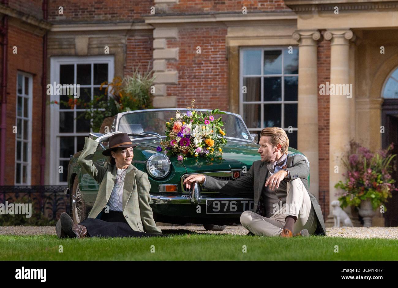 Jayne Barrett and her husband Craig Barrett, pose with a floral bouquet ...