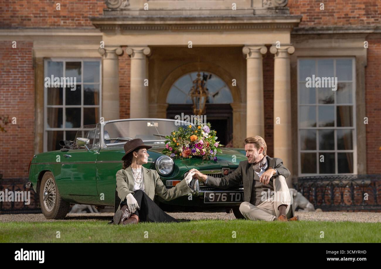 Jayne Barrett and her husband Craig Barrett, pose with a floral bouquet ...