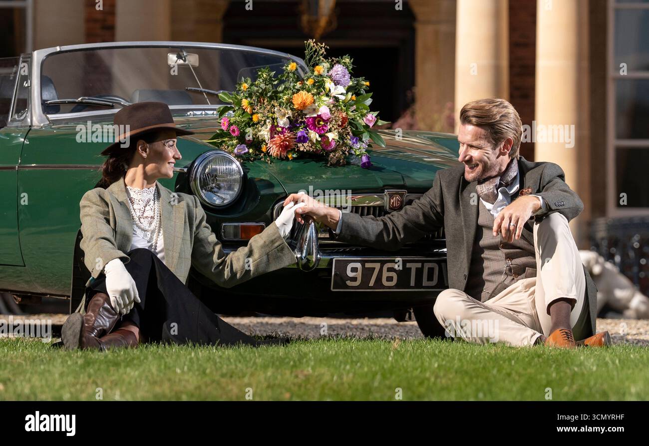 Jayne Barrett and her husband Craig Barrett, pose with a floral bouquet ...