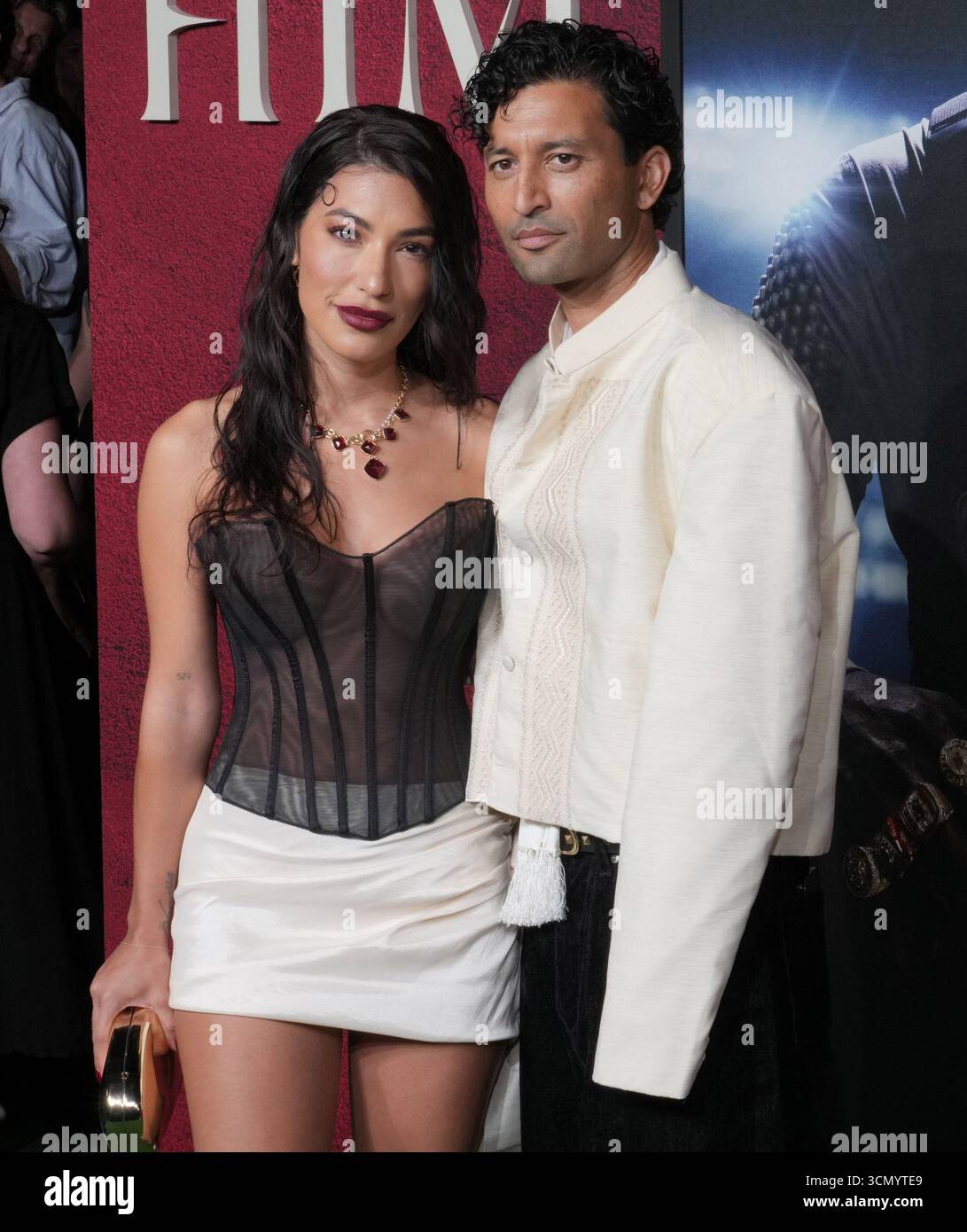 (R-L) Justin Tipping and Guest arrives at the Universal Pictures' HIM Premiere held at the TCL ...