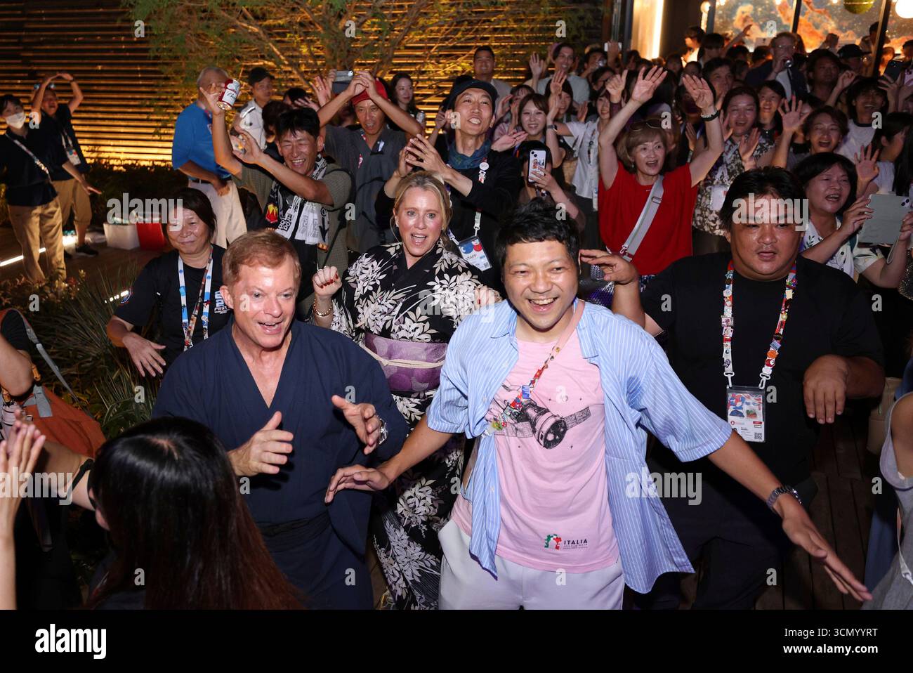 People enjoying Bon dance at the U.S. Pavilion of the Kansai Osaka Expo ...