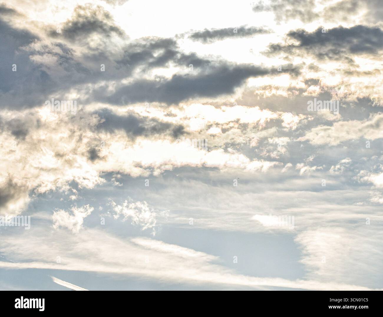 Sky scene with gentle daylight through bright and dark clouds ...