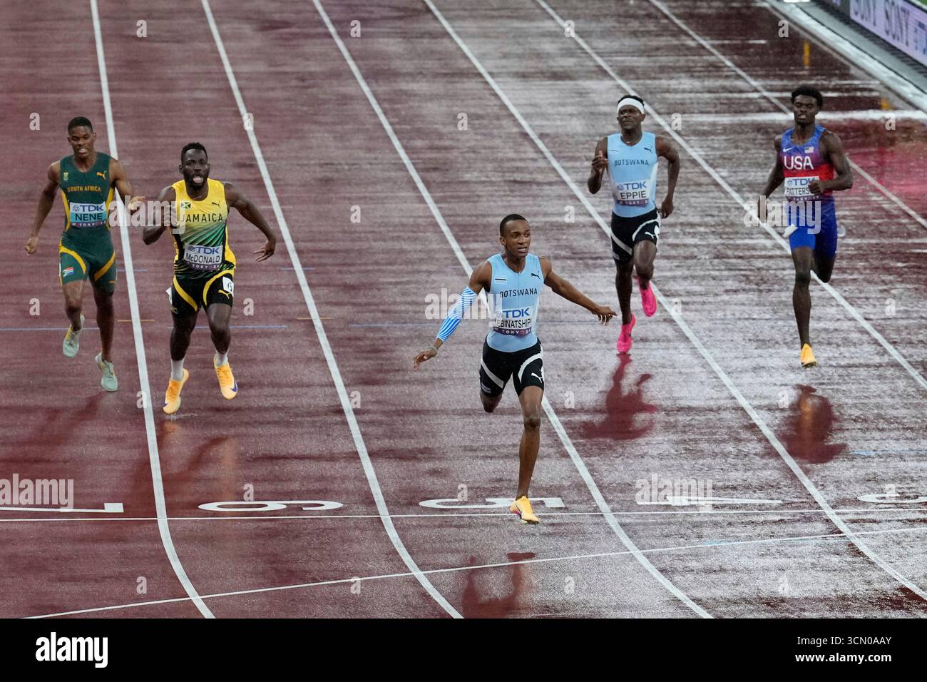 Botswana's Busang Collen Kebinatshipi, center, crosses the finish line ...