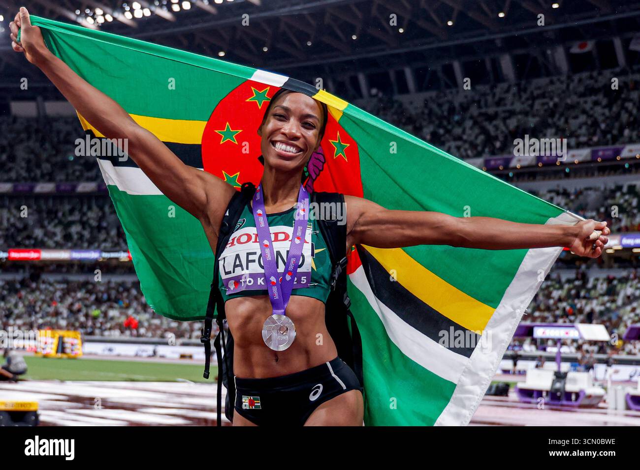 second place Thea Lafond of Dominica showing her silver medal and ...