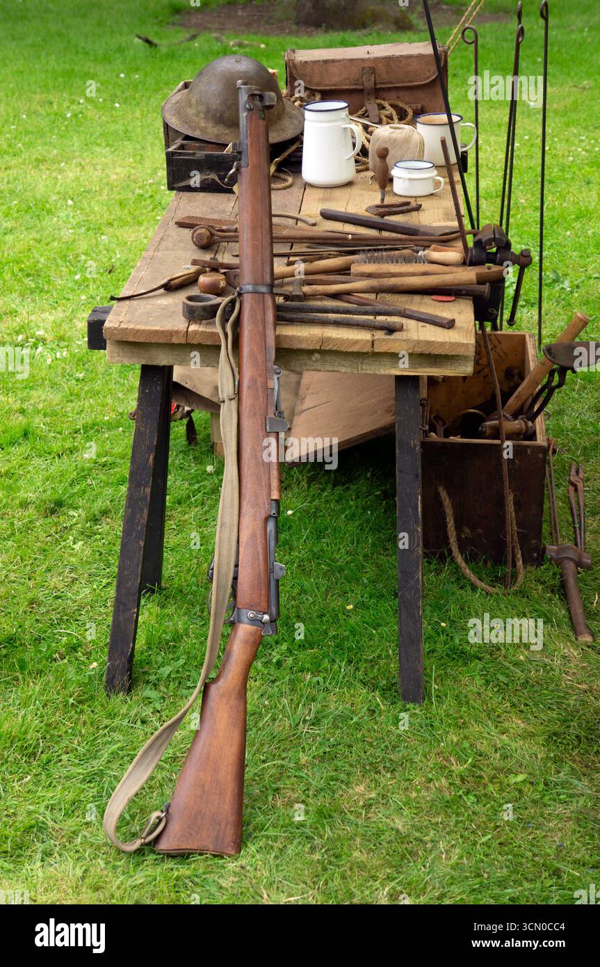 A first world War Lee Enfield Rifle No. 4 leaning against a table at a ...