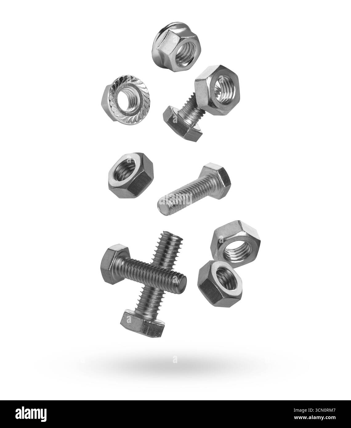 Metal nuts and bolts falling against white background Stock Photo - Alamy