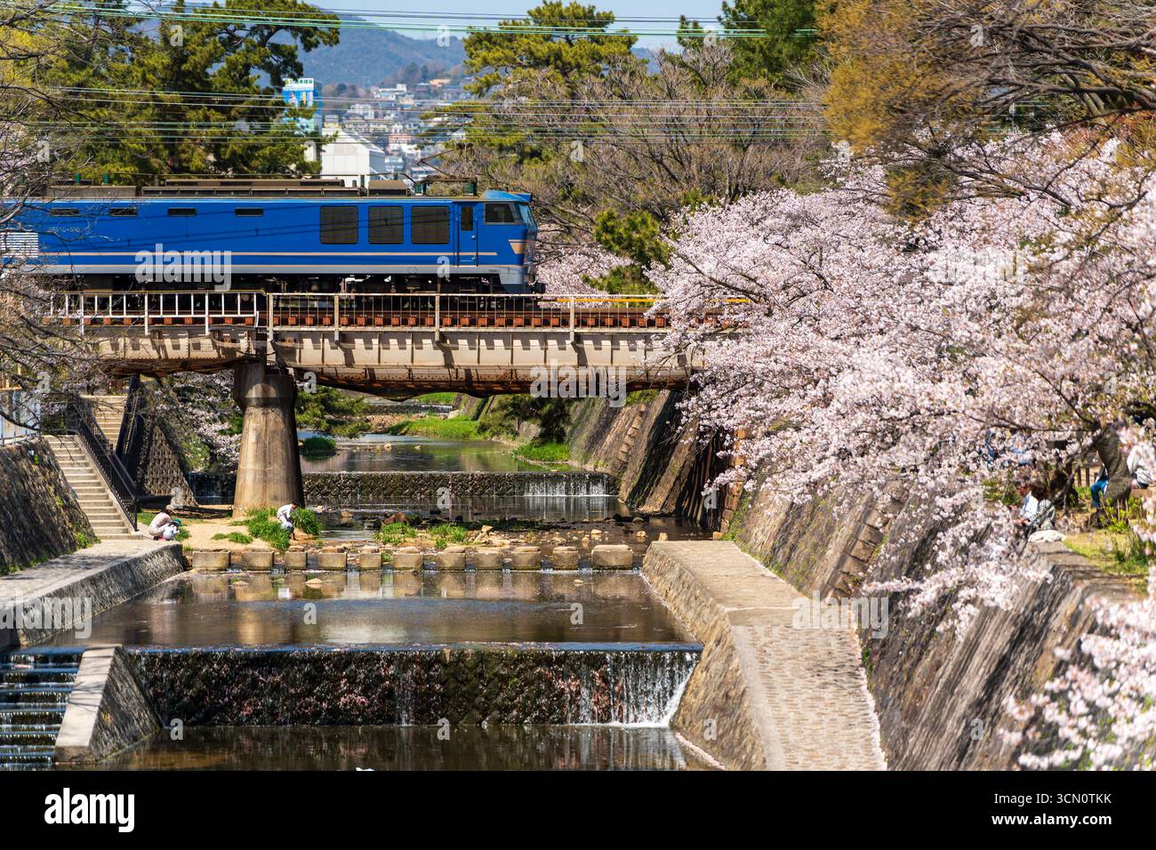 Nishinomiya, Hyogo, Japan. JR Kobe Line train crossing a bridge over ...
