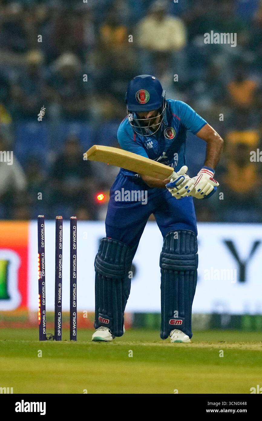 Afghanistan's Karim Janat is bowled out by Sri Lanka's Nuwan Thushara ...