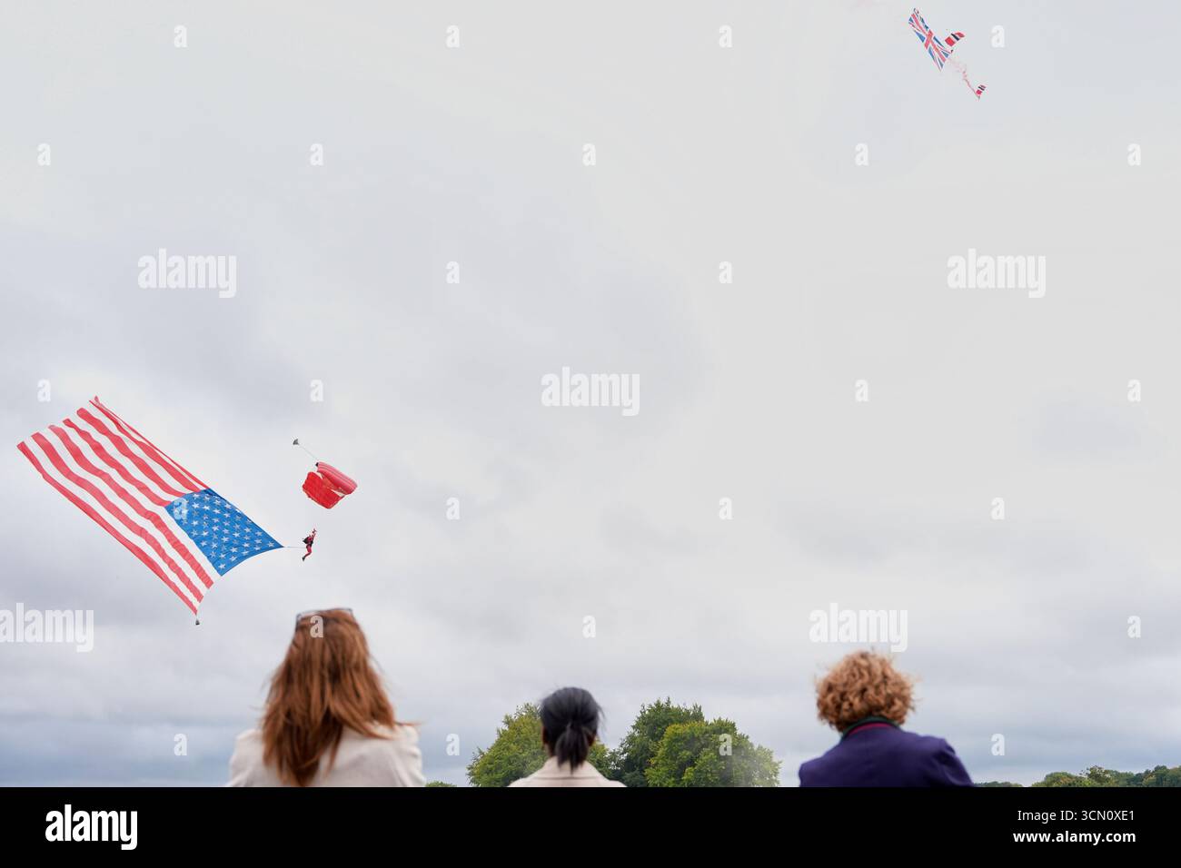 Guests watch a display by the British Parachute Regiment's "Red Devils ...