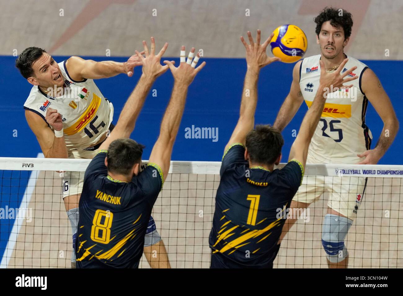 Yuri Romano, left, of Italy spikes the ball against Ukraine during ...