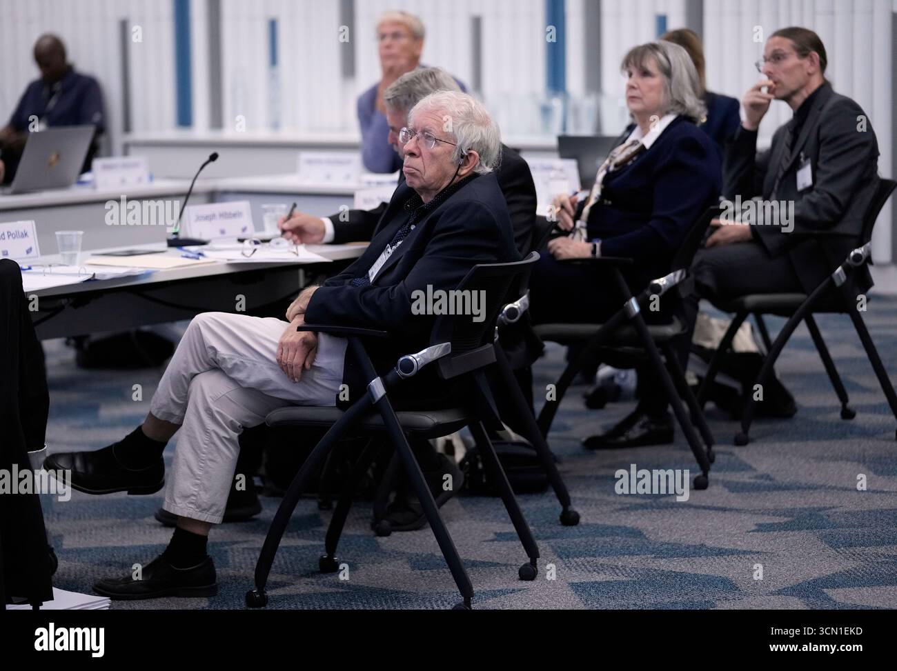 Committee members, Dr. Raymond Pollak, center, listen during a meeting ...