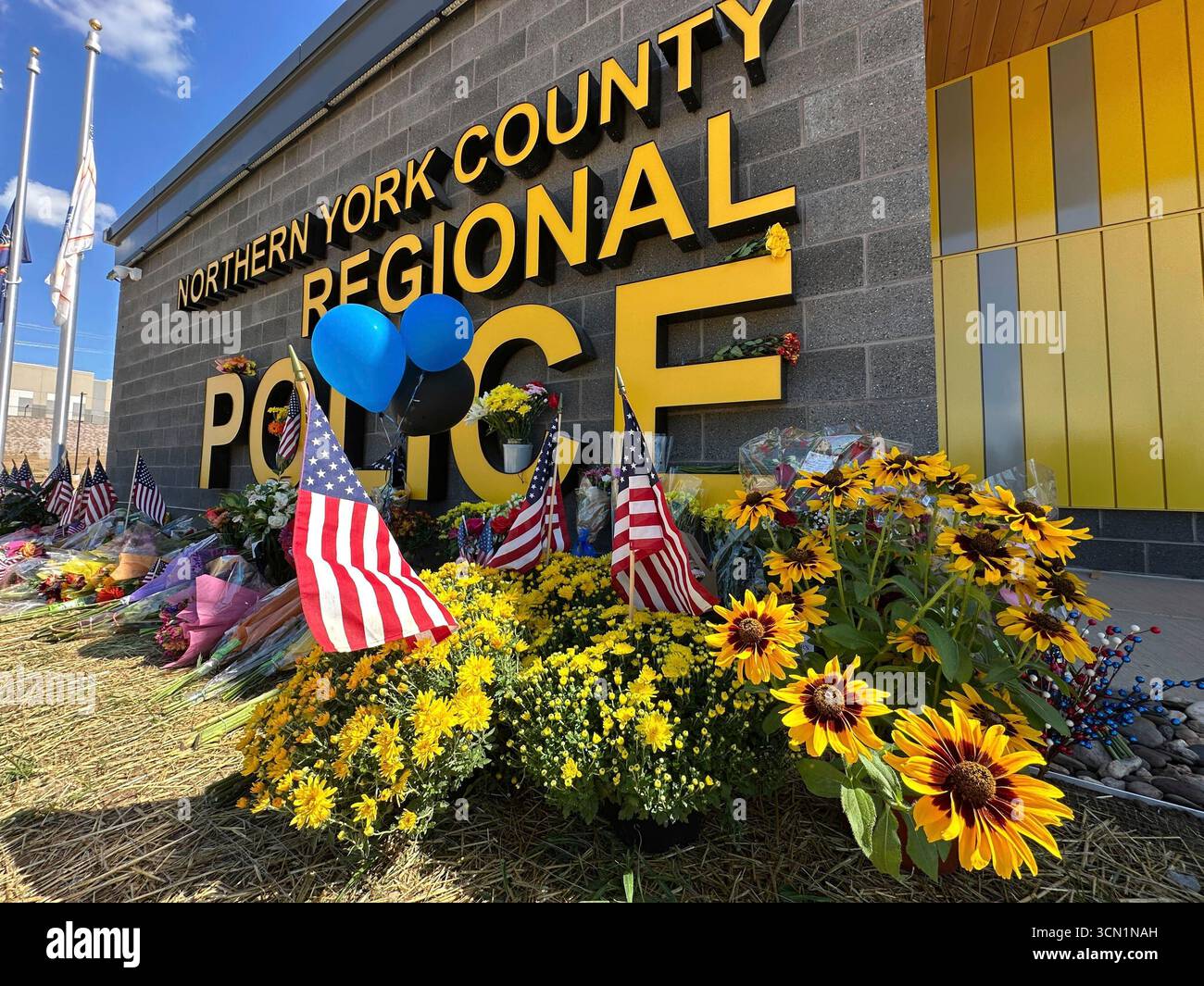 A memorial for police officers killed in a shooting is shown outside ...