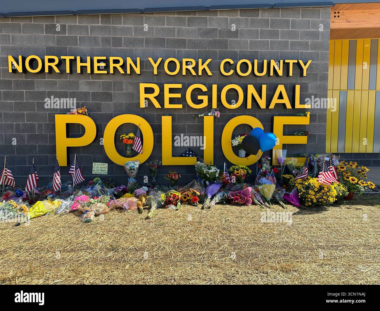 A memorial for police officers killed in a shooting is shown outside ...