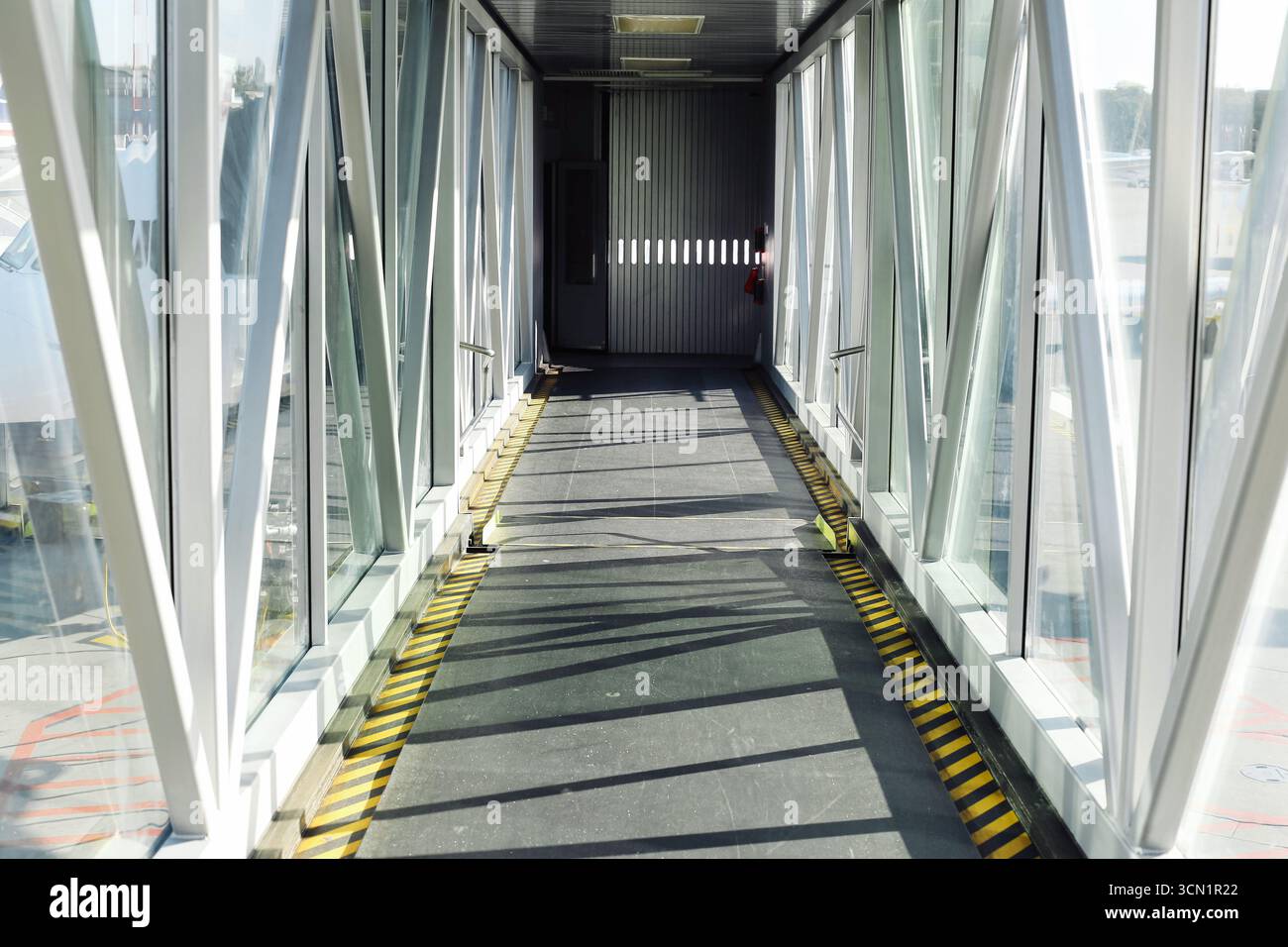 Empty airport jet bridge tunnel. Passenger boarding corridor walkway ...