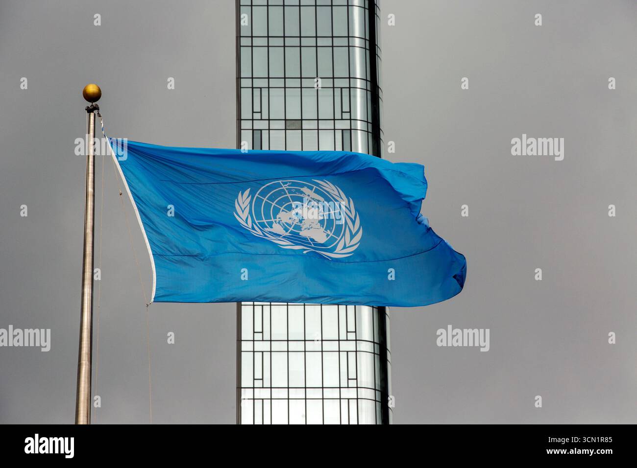 FILE - The UN flag flies on a stormy day at the United Nations during ...