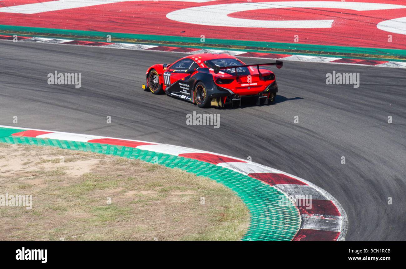 Dynamic Ferrari Race Car on Track - A red and black Ferrari 488 GT3 Evo ...