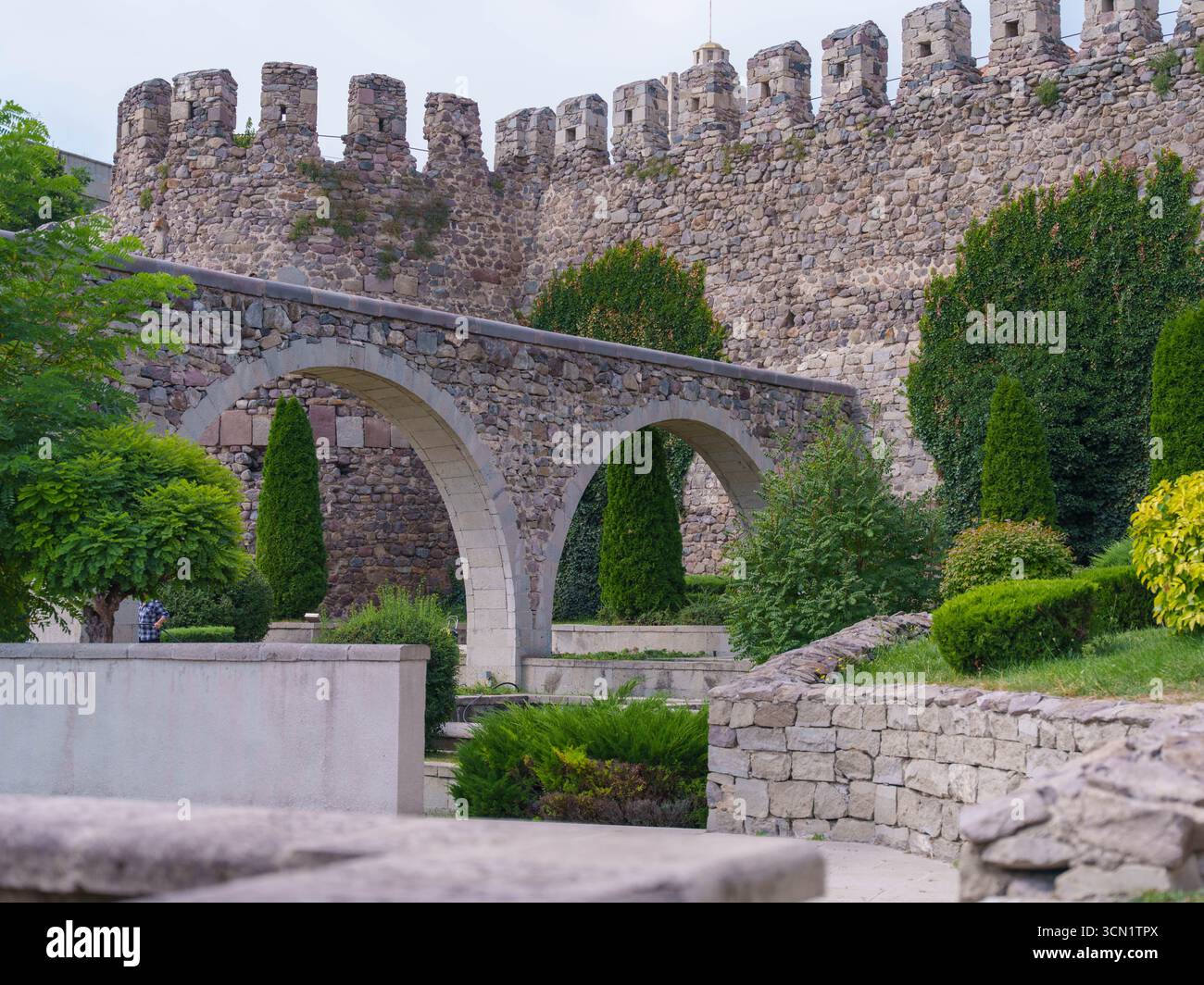 Medieval Stone Fortress with Round Tower and Garden Path Stock Photo ...
