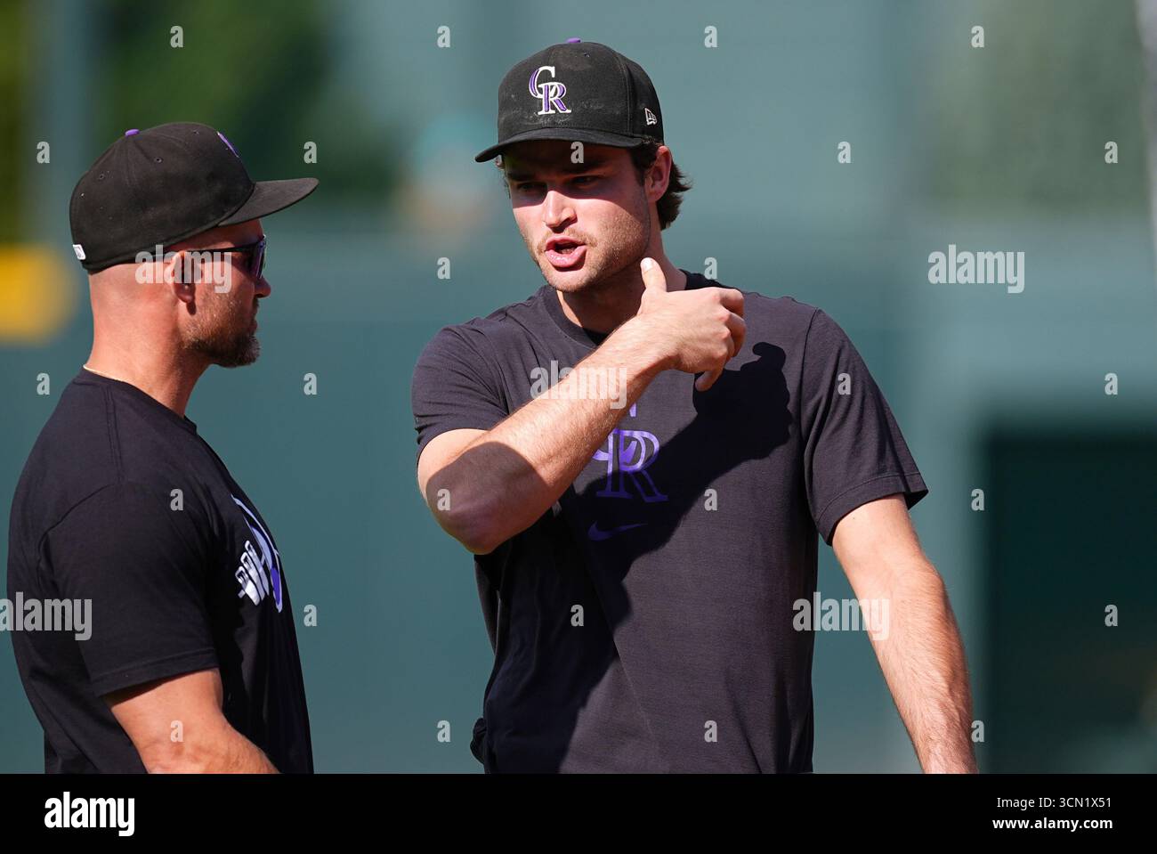 Colorado Rockies interim manager Warren Schaeffer (34) confers with ...