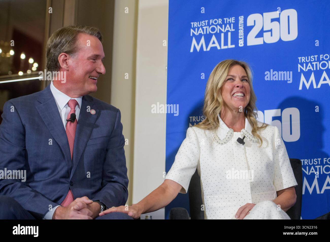 Virginia Gov. Glenn Youngkin, left, looks on as his wife, first lady of ...