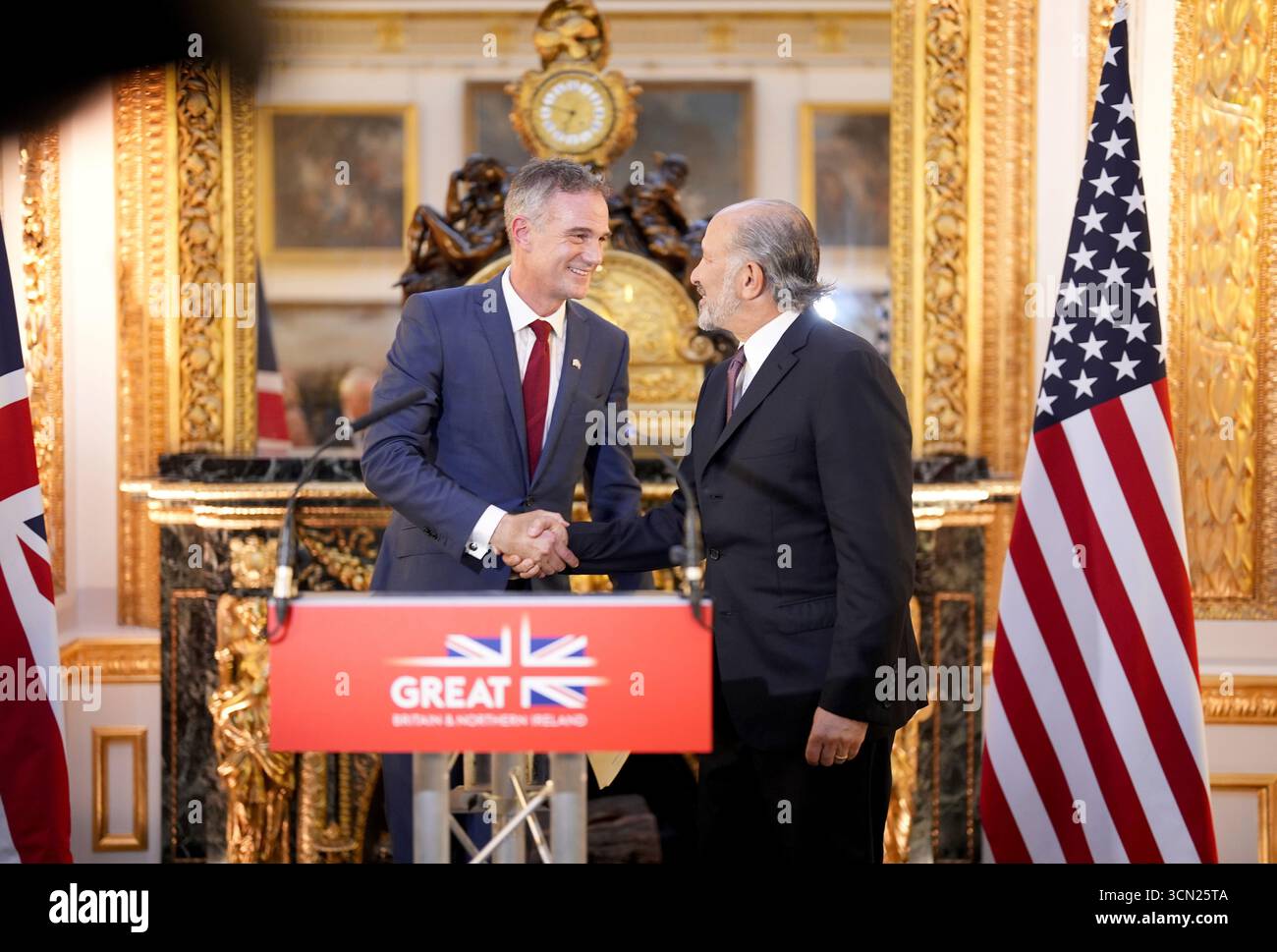 U.S. Secretary of Commerce Howard Lutnick, right, shakes hands with ...