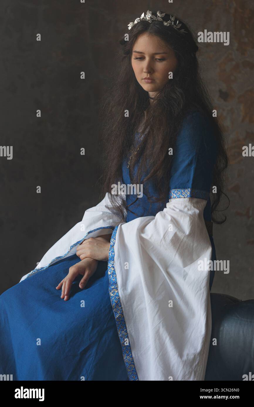 Sad fantasy princess in a blue dress, portrait of a beautiful brunette ...