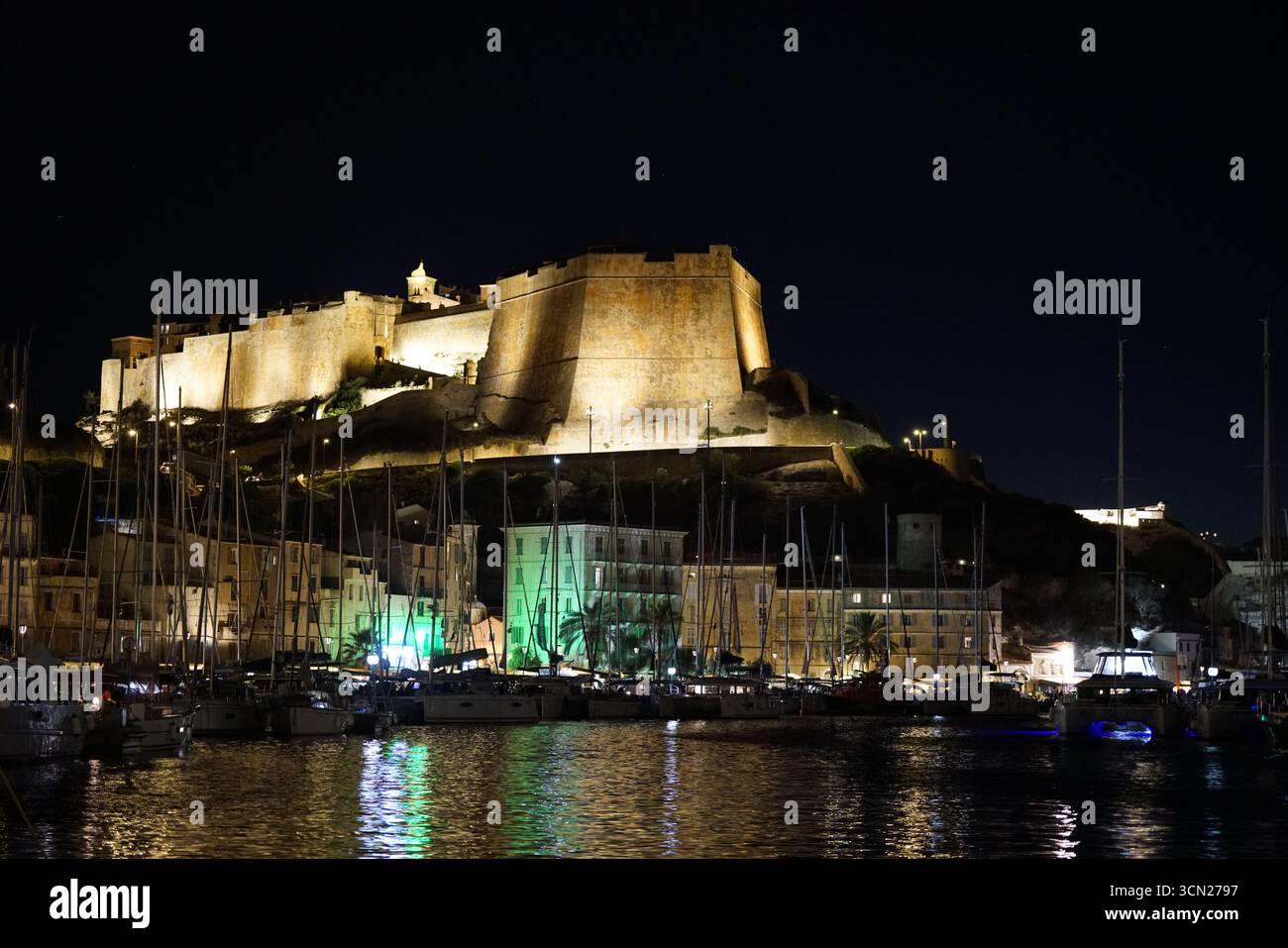 Night View Of Seaside Fortress Overlooking Harbor With Illuminated ...