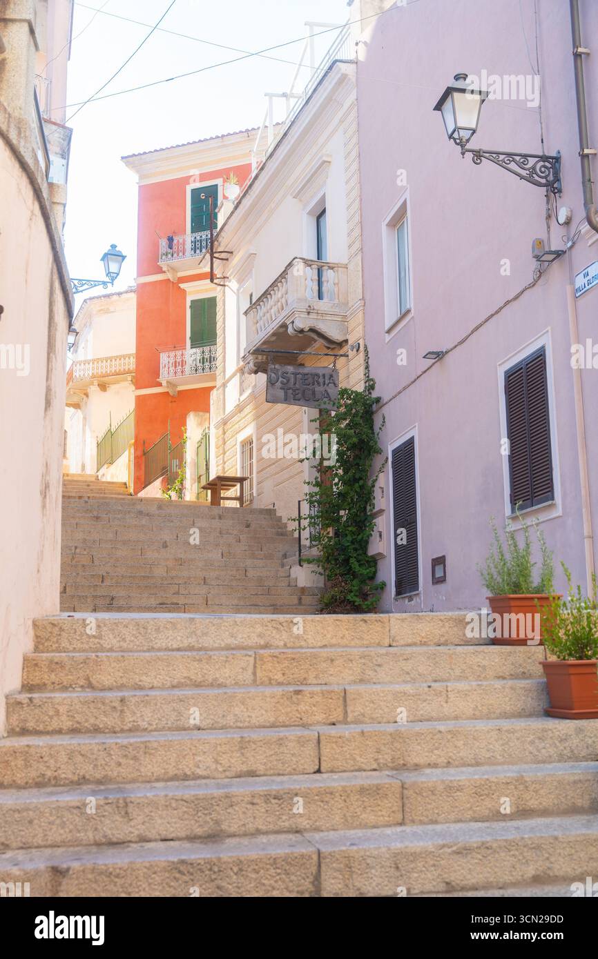 Picturesque Italian street with stone steps leading to colorful ...
