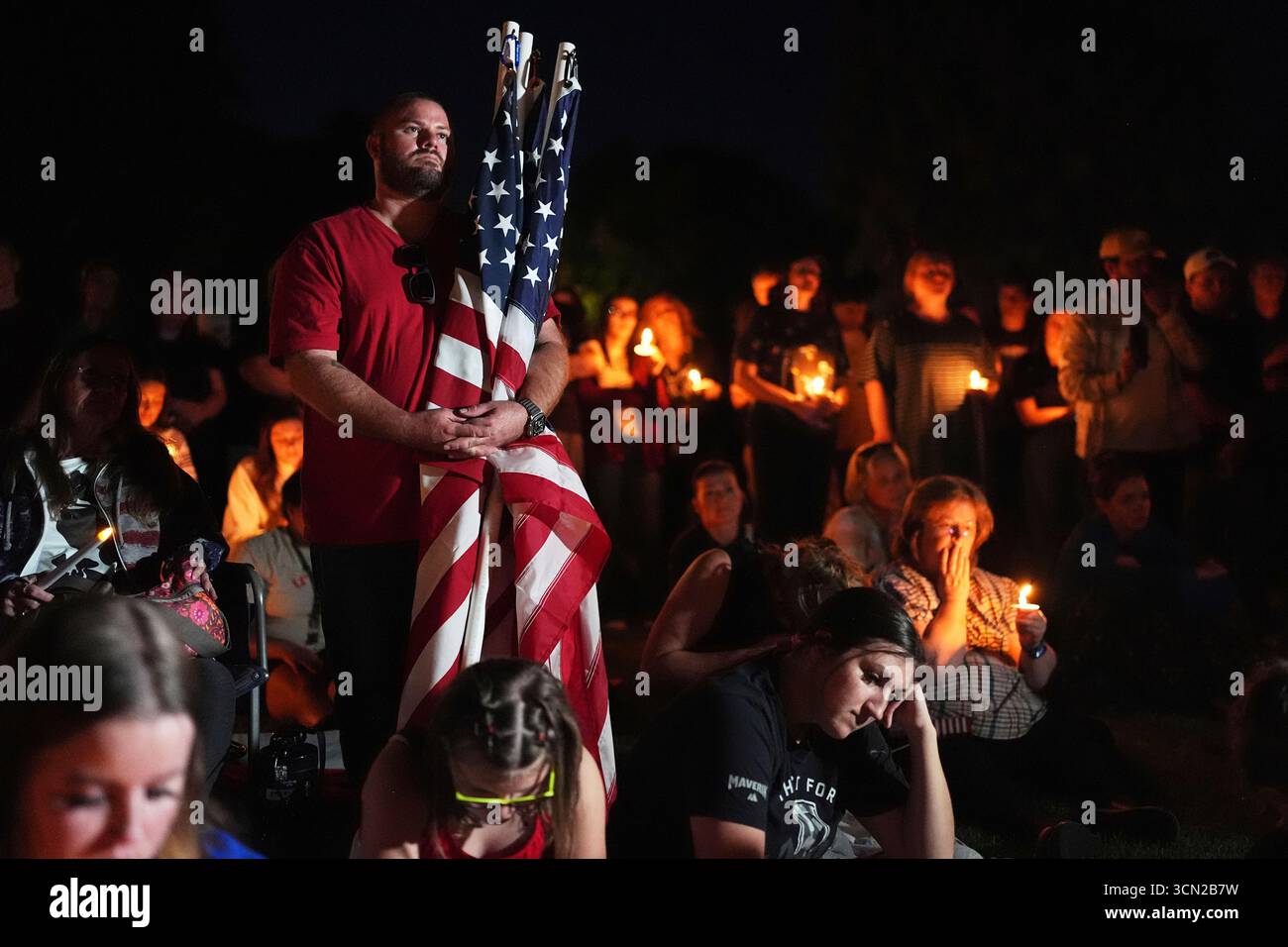Ryan Shaw holds American flags during a vigil for Charlie Kirk on ...