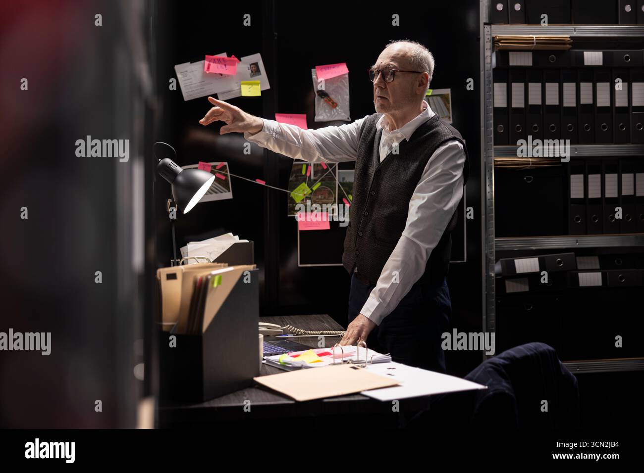 Senior man detective studying evidence and making connections ...